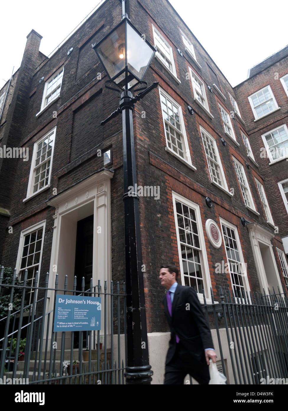 A man in a suit walking past Dr. Samuel Johnson House Gough Square ...