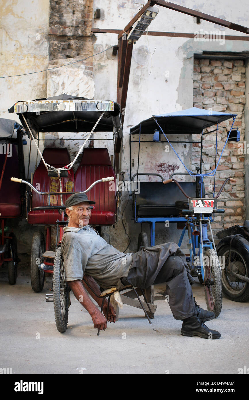 An old rickshaw driver relaxes in a chair in Havanna, Cuba, 22 ...