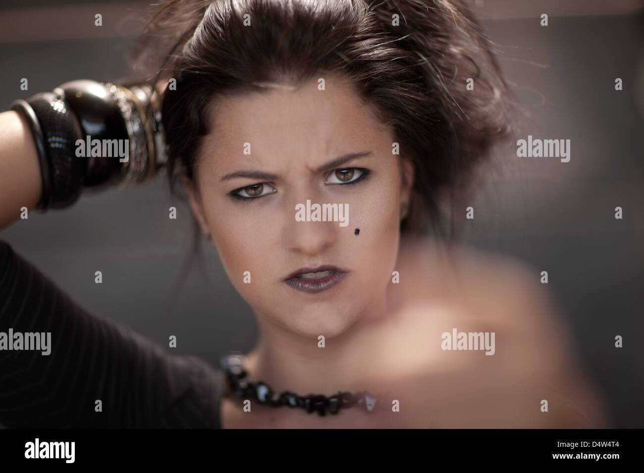 Teenage girl in dark makeup pointing Stock Photo - Alamy