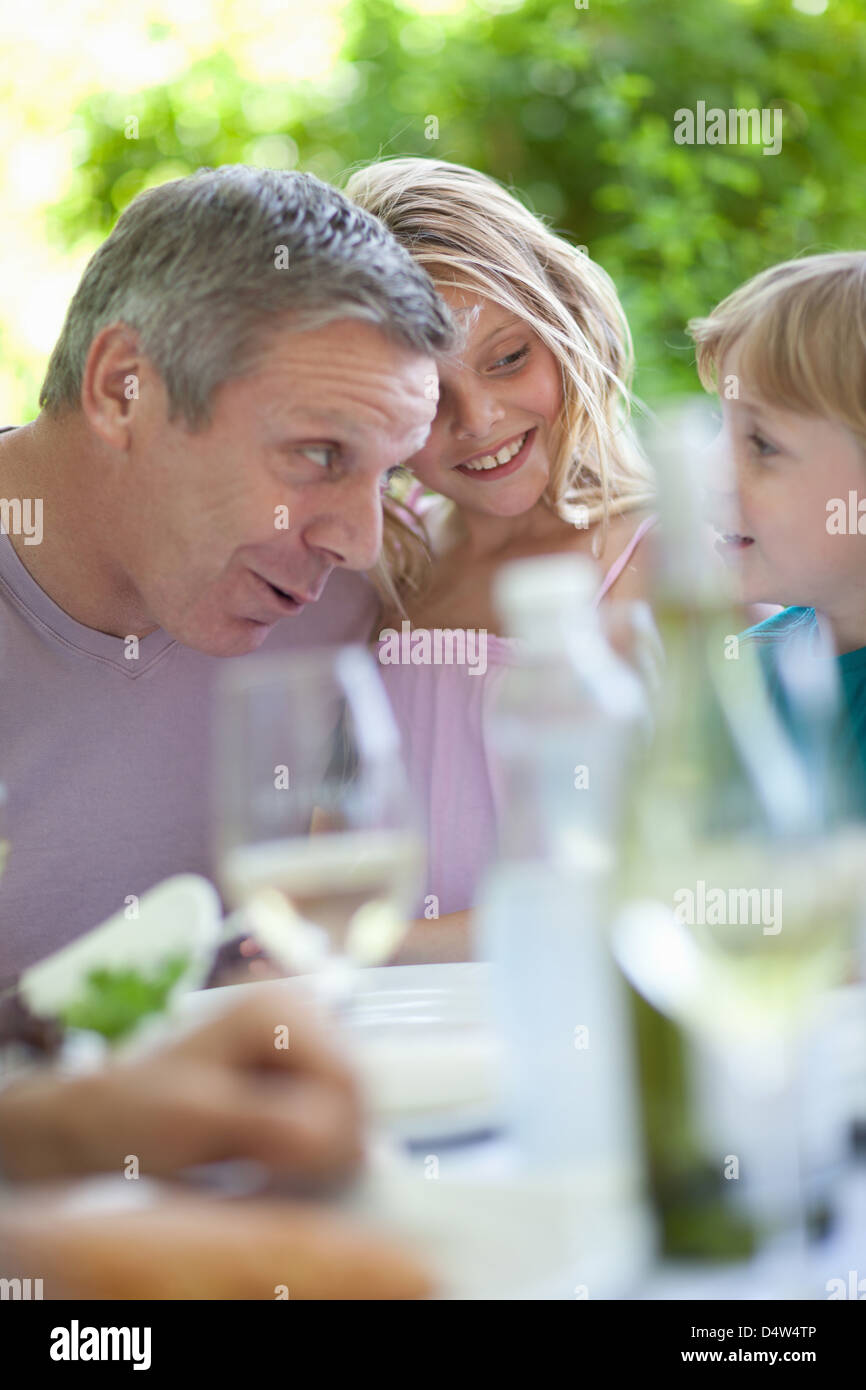 Father and son talking at table outdoors Stock Photo - Alamy