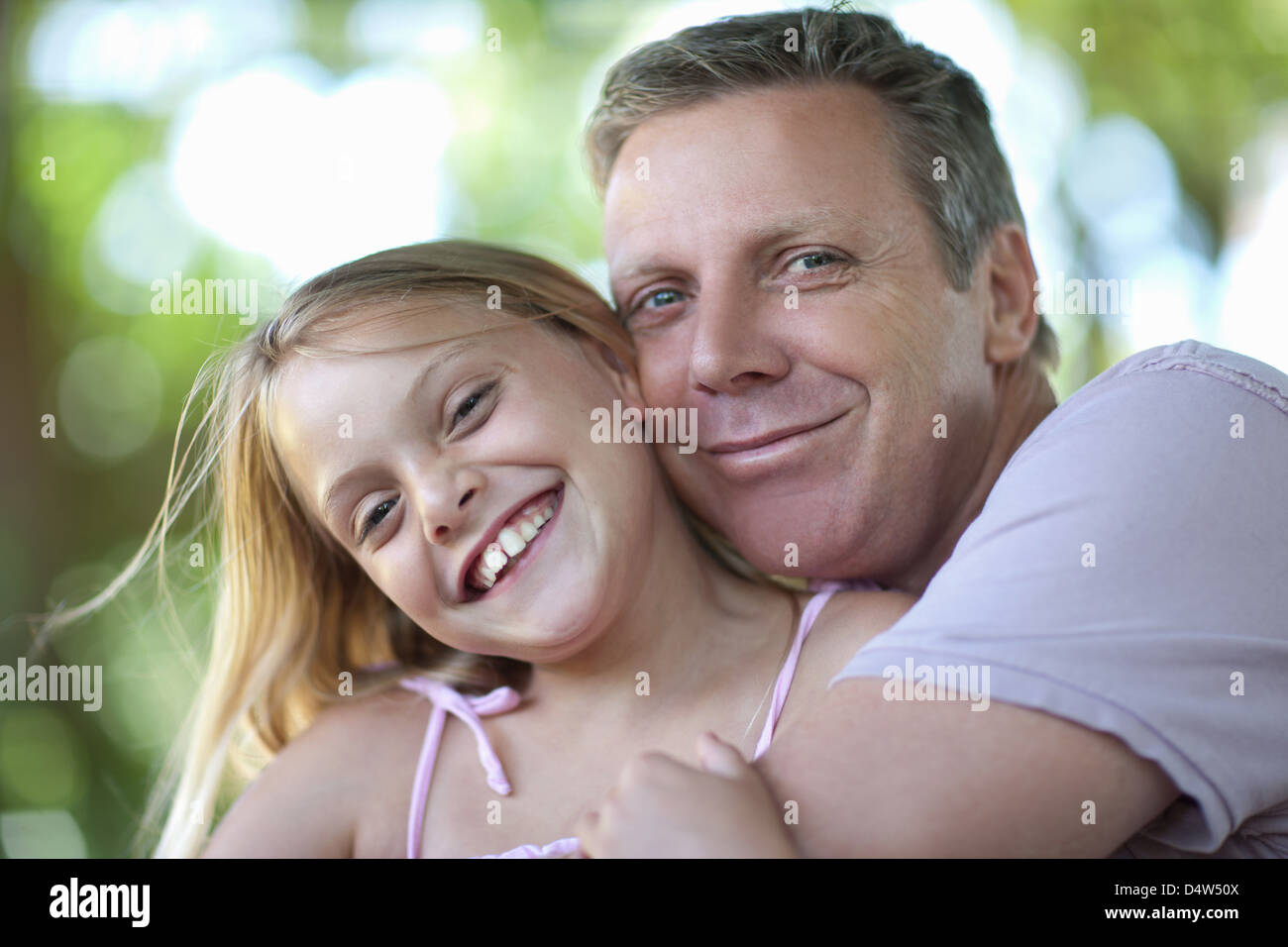 Father hugging daughter outdoors Stock Photo - Alamy