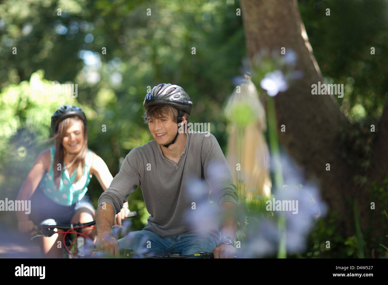 Couple riding mountain bikes together Stock Photo - Alamy