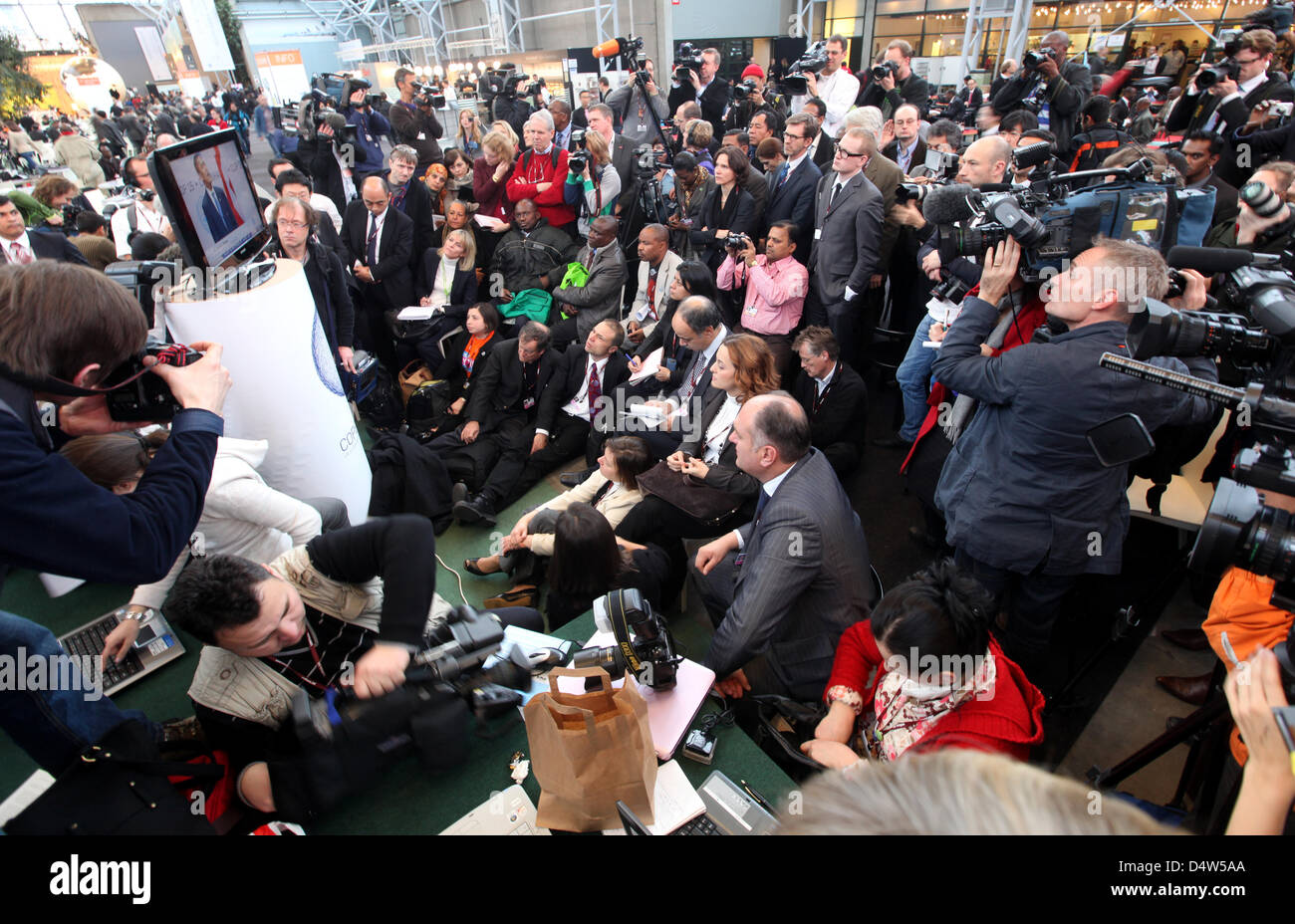 Journalists follow US President Barack Obama's speech on a monitor at ...