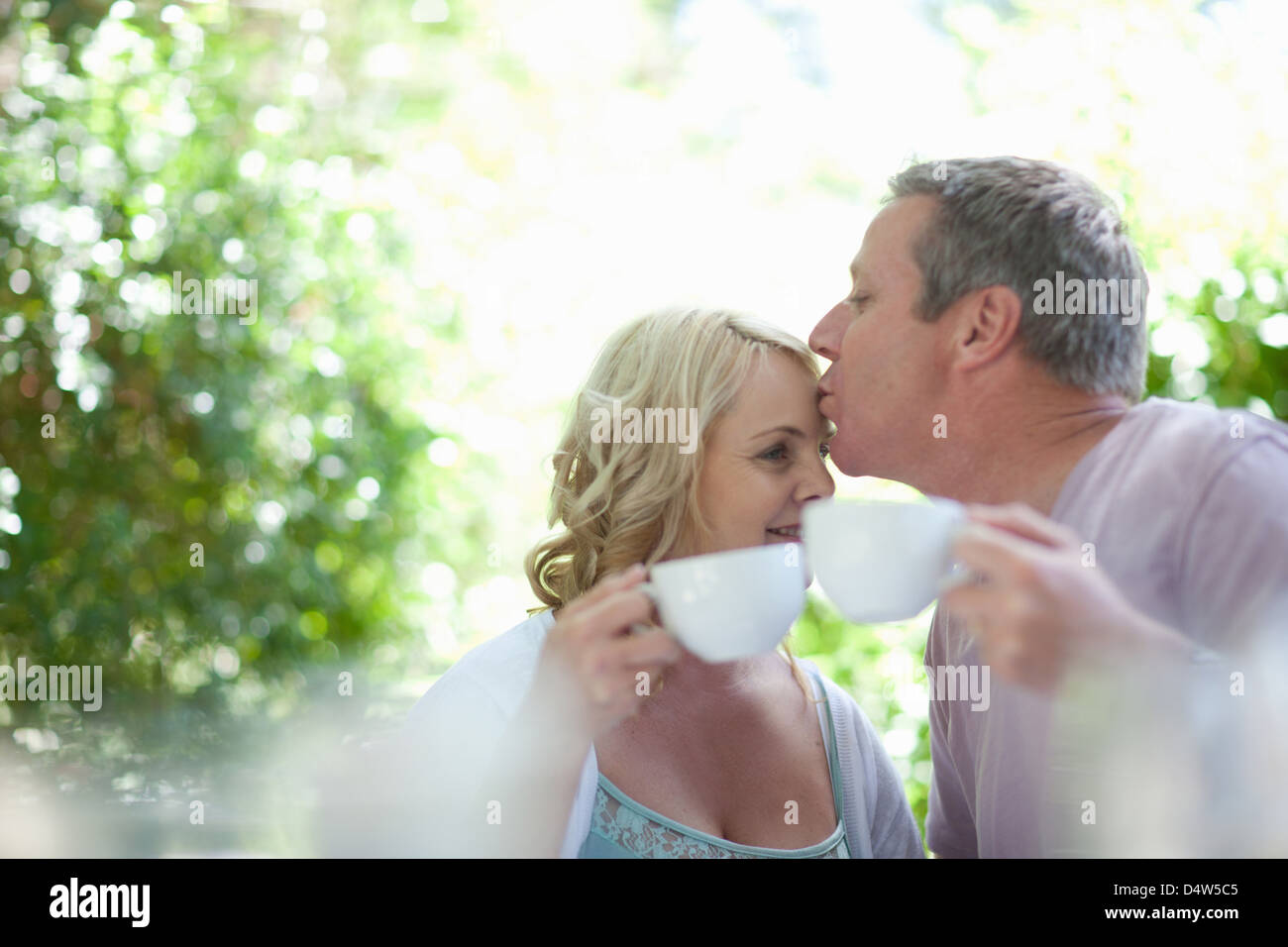 Couple having coffee together outdoors Stock Photo - Alamy