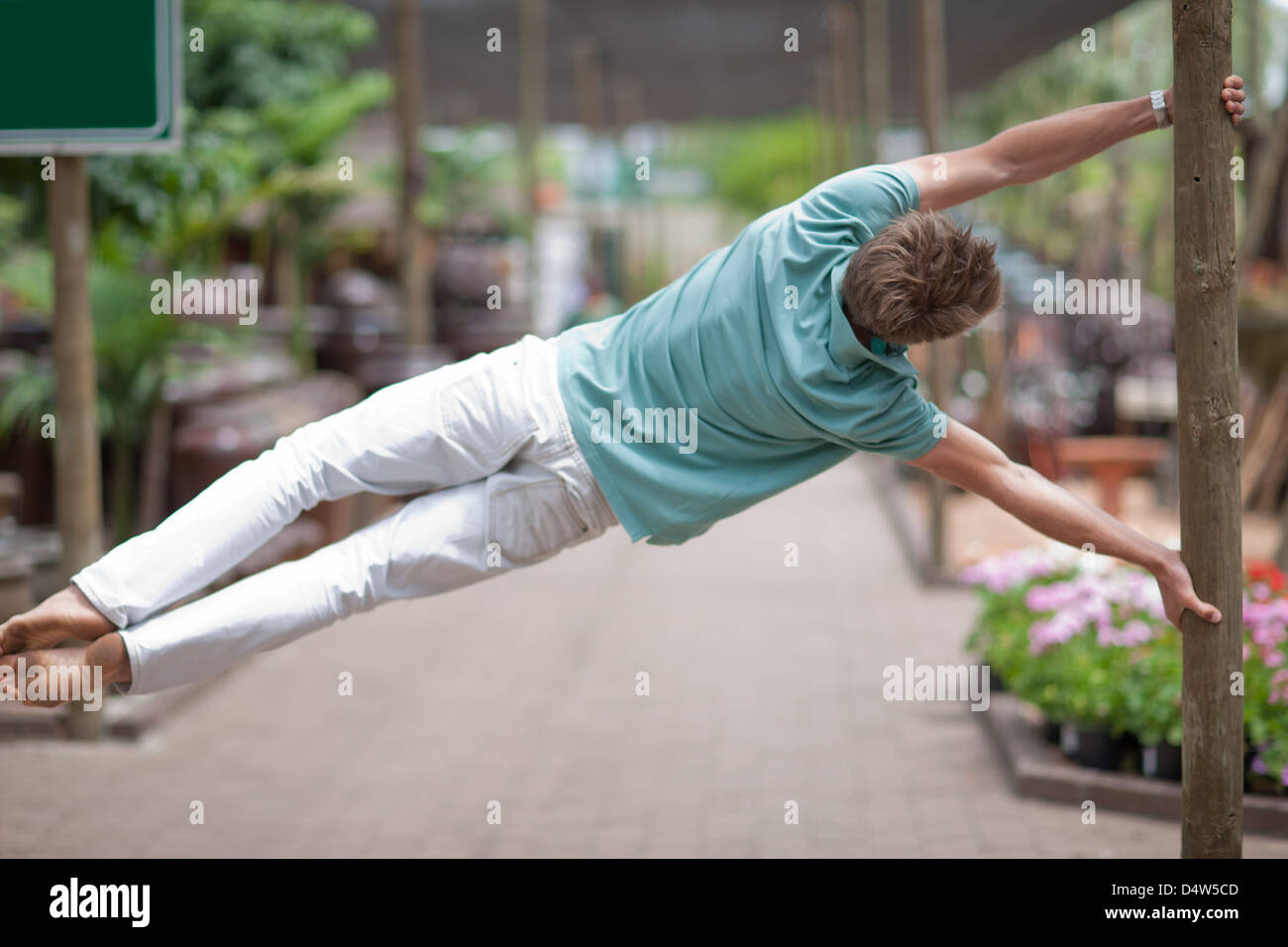 Man swinging from pole hi-res stock photography and images - Alamy