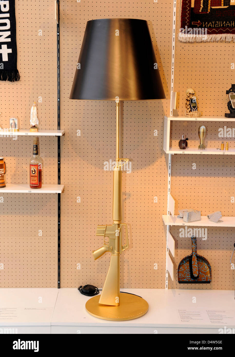 A rifle-shaped standard-lamp forms part of the exhibition 'The bad ...
