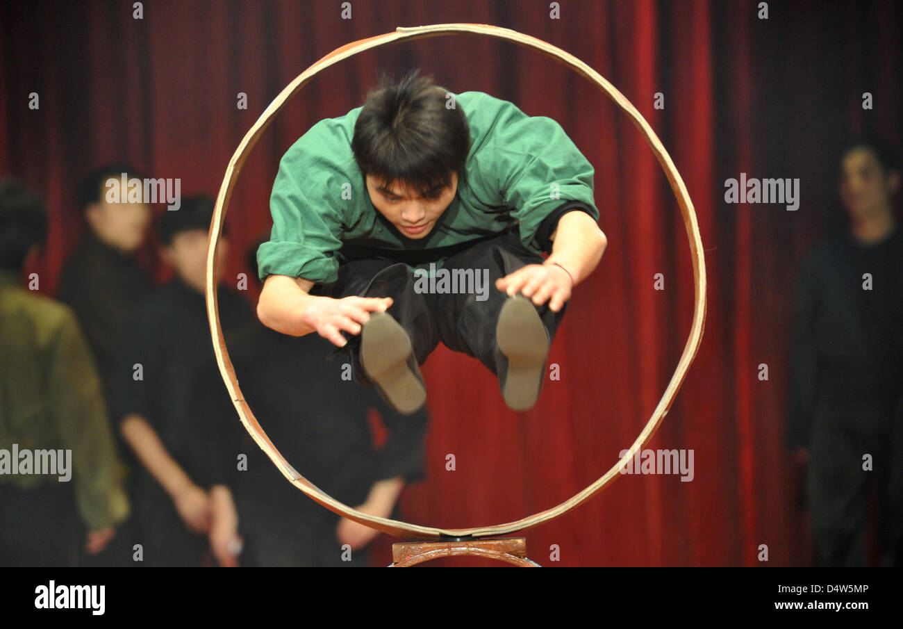 A member of Shenyang Acrobatic Troupe performs at the premiere of ...