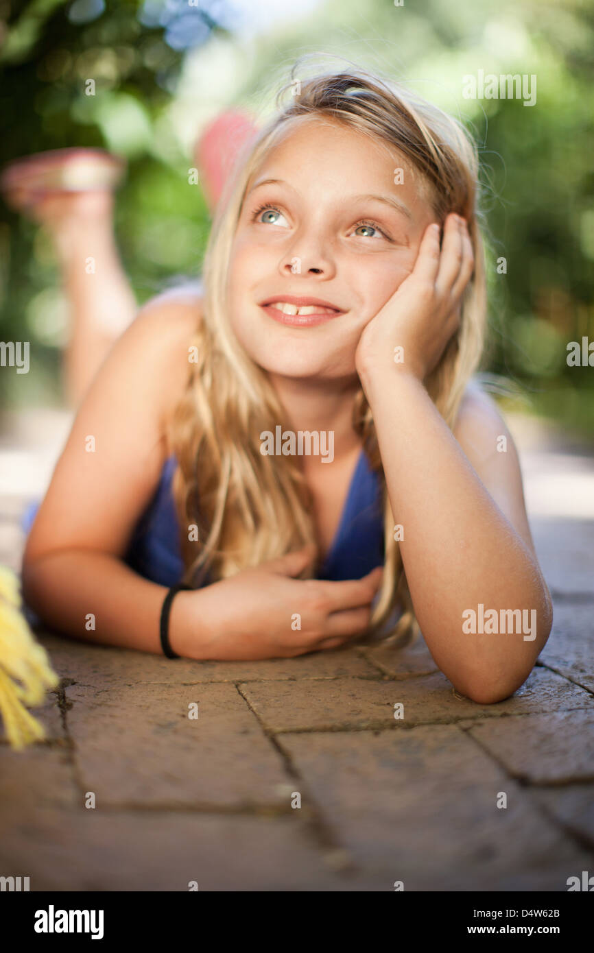 Girl laying on ground outdoors Stock Photo - Alamy