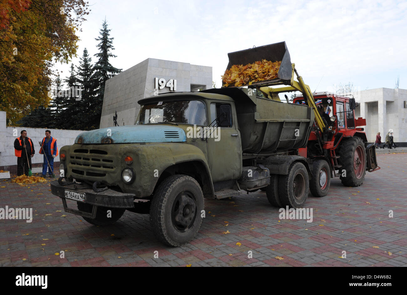 An excavator loads leaves onto an old lorry in Kursk, Russia, 16 ...