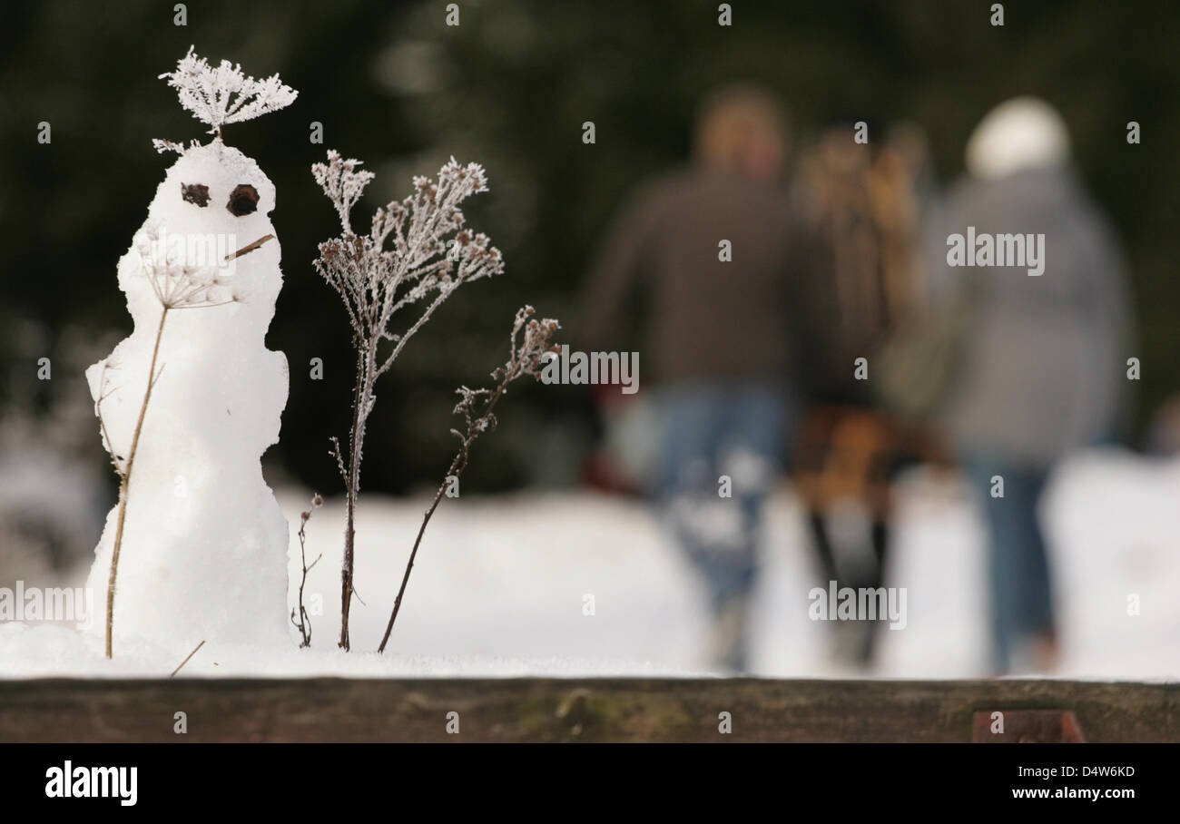 A small snowman stands at a parking lot in Drei-Annen-Hohne, Germany ...