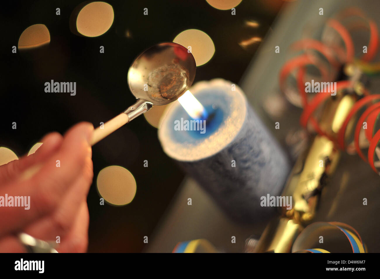 A piece of lead is being melted over a candle in Hanover, Germany, 31 ...