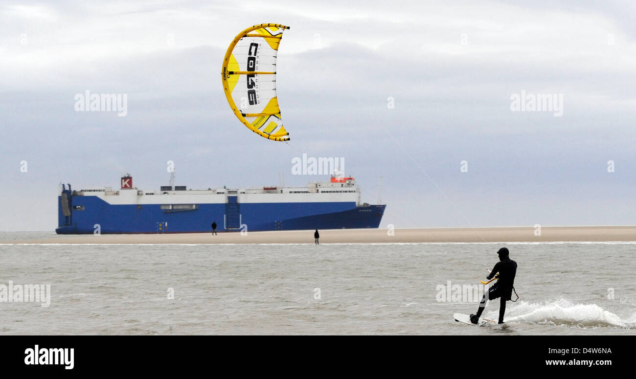 A kite surfer shown in action at the beach of the island Borkum in the ...