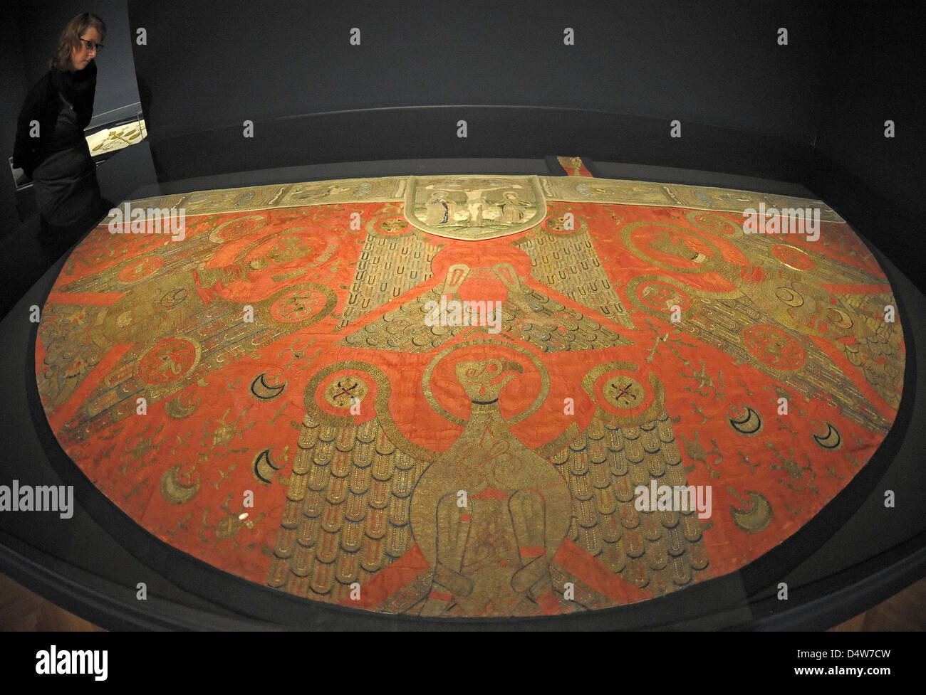 A woman examines the coronation robe of Frederick II from the early ...
