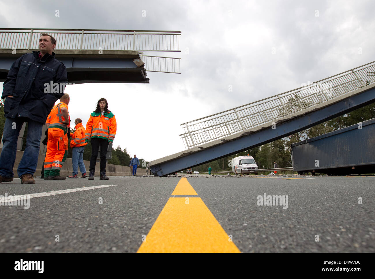 A damaged pedestrian bridge lies across the German Autobahn A2 near ...