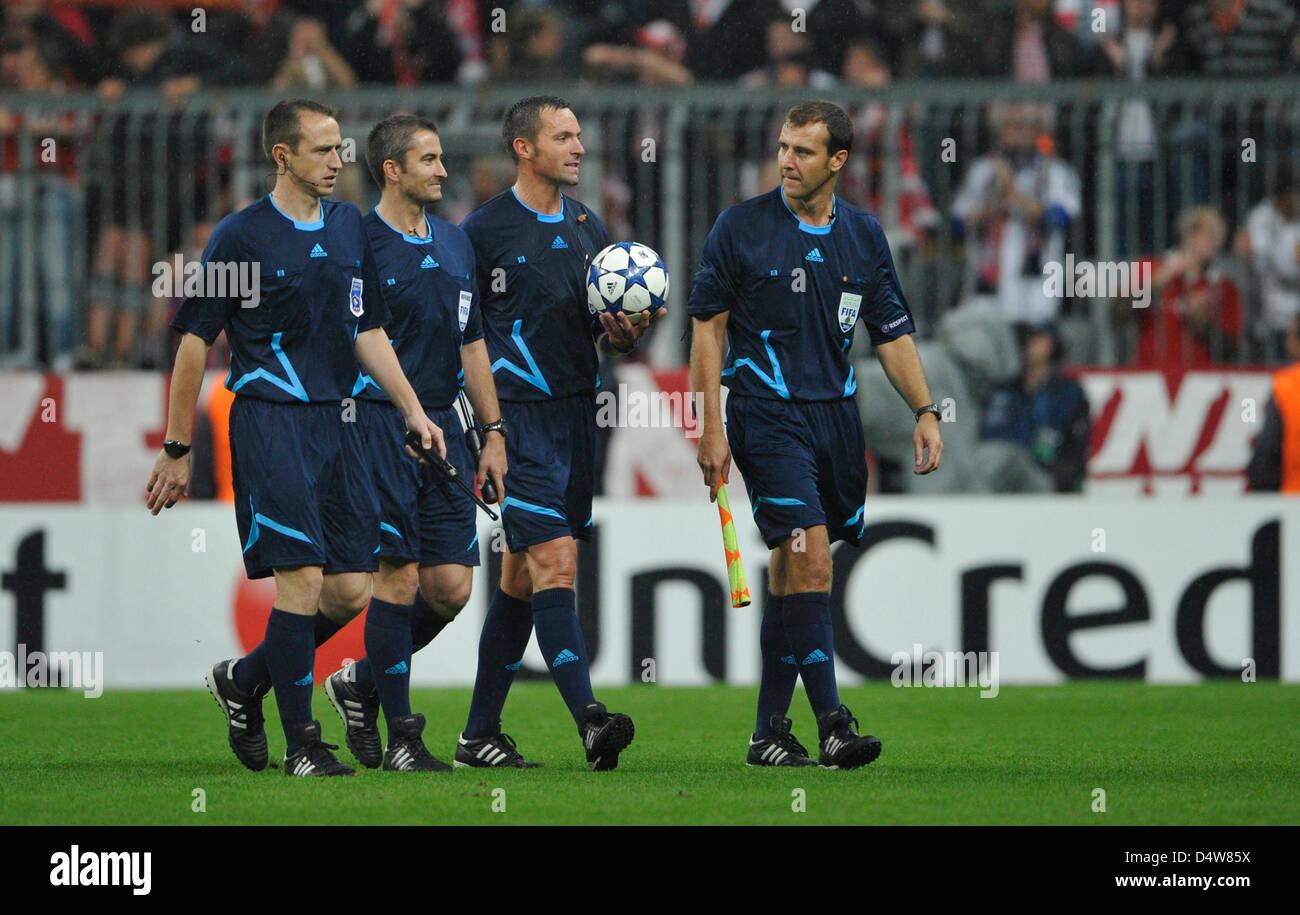 The referees and the goal-referee (L) walk onto the pitch during the ...
