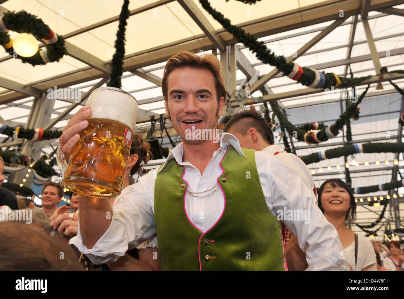 German folk singer Florian Silbereisen poses with a Mass of beer as the ...
