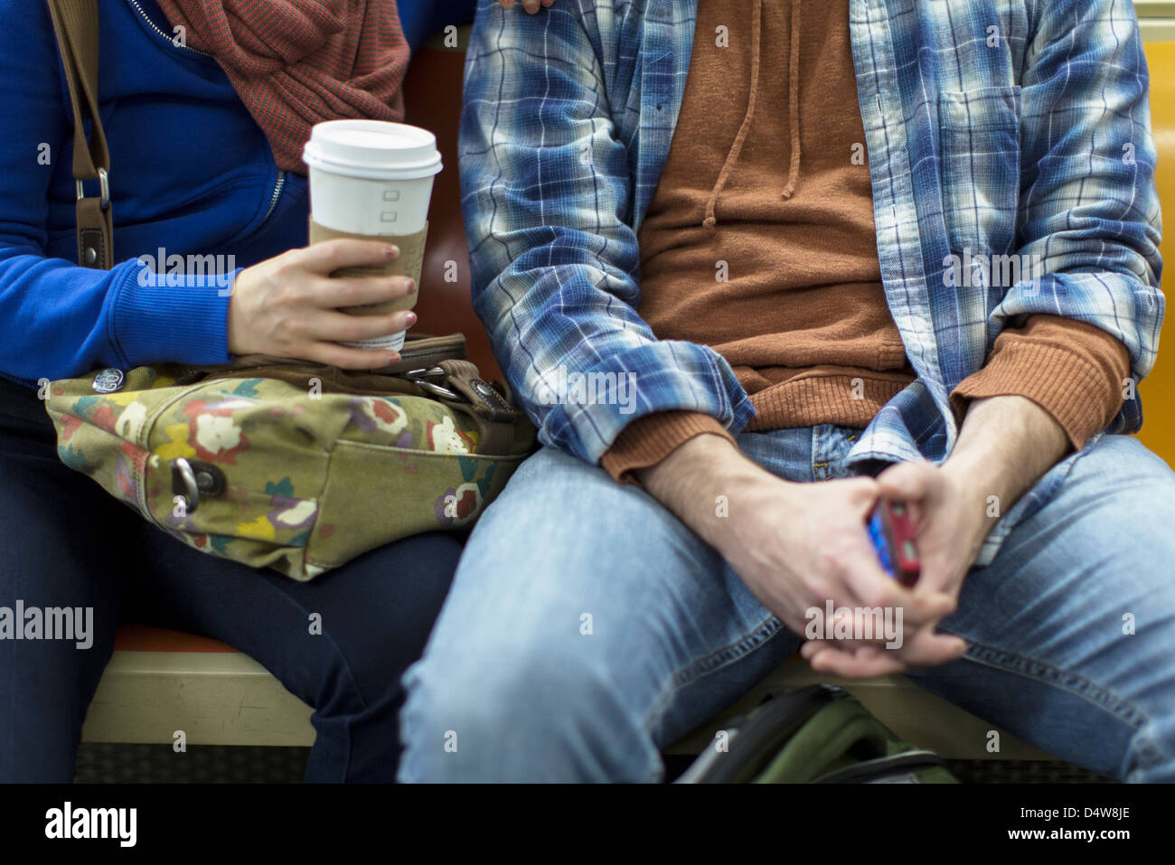 Couple sitting on urban subway Stock Photo - Alamy