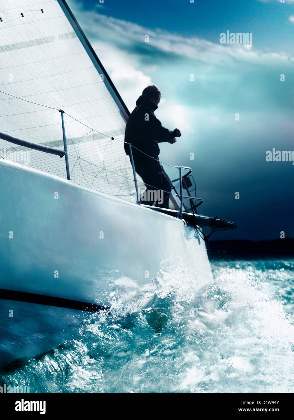 Man trimming sails on yacht in race Stock Photo - Alamy