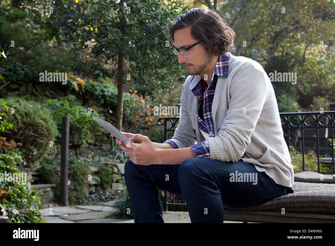 Man looking tablet wireless lighting hi-res stock photography and ...