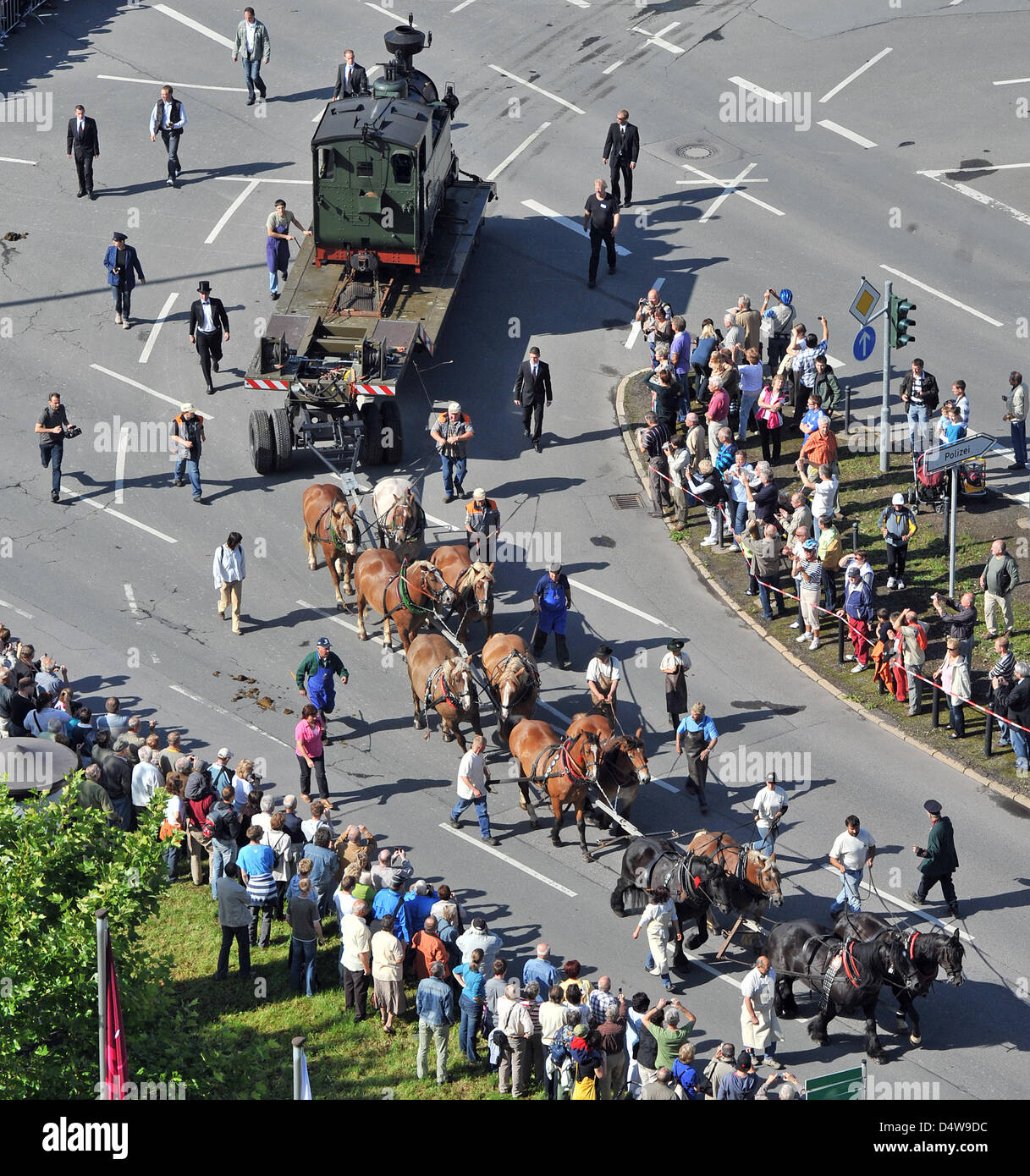 Twelve horses drag the renovated lightweight, narrow-gauge locomotive ...