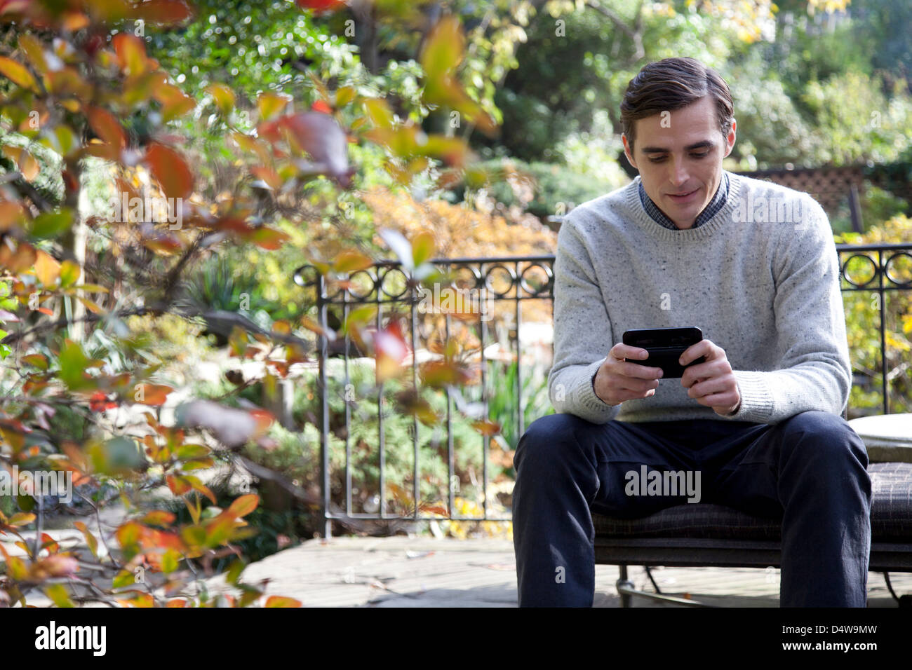 Man using cell phone outdoors Stock Photo - Alamy