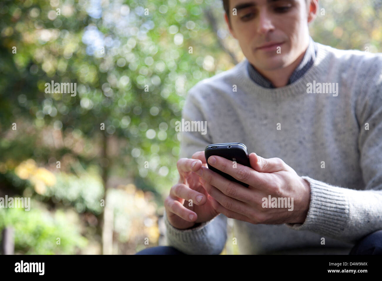 Man using cell phone outdoors Stock Photo - Alamy