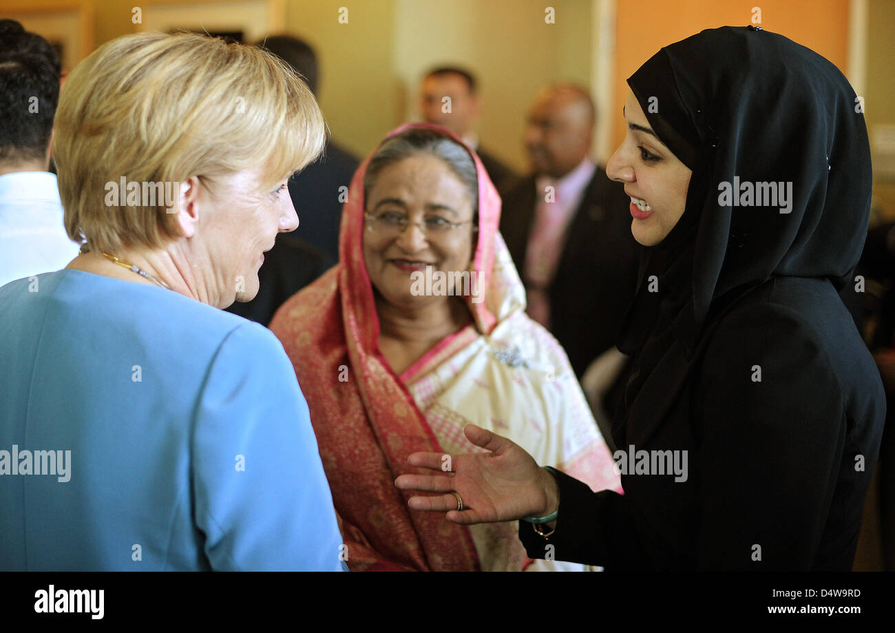 German Chancellor Angela Merkel (L) greets Minister Reem Al Hashimy (R ...