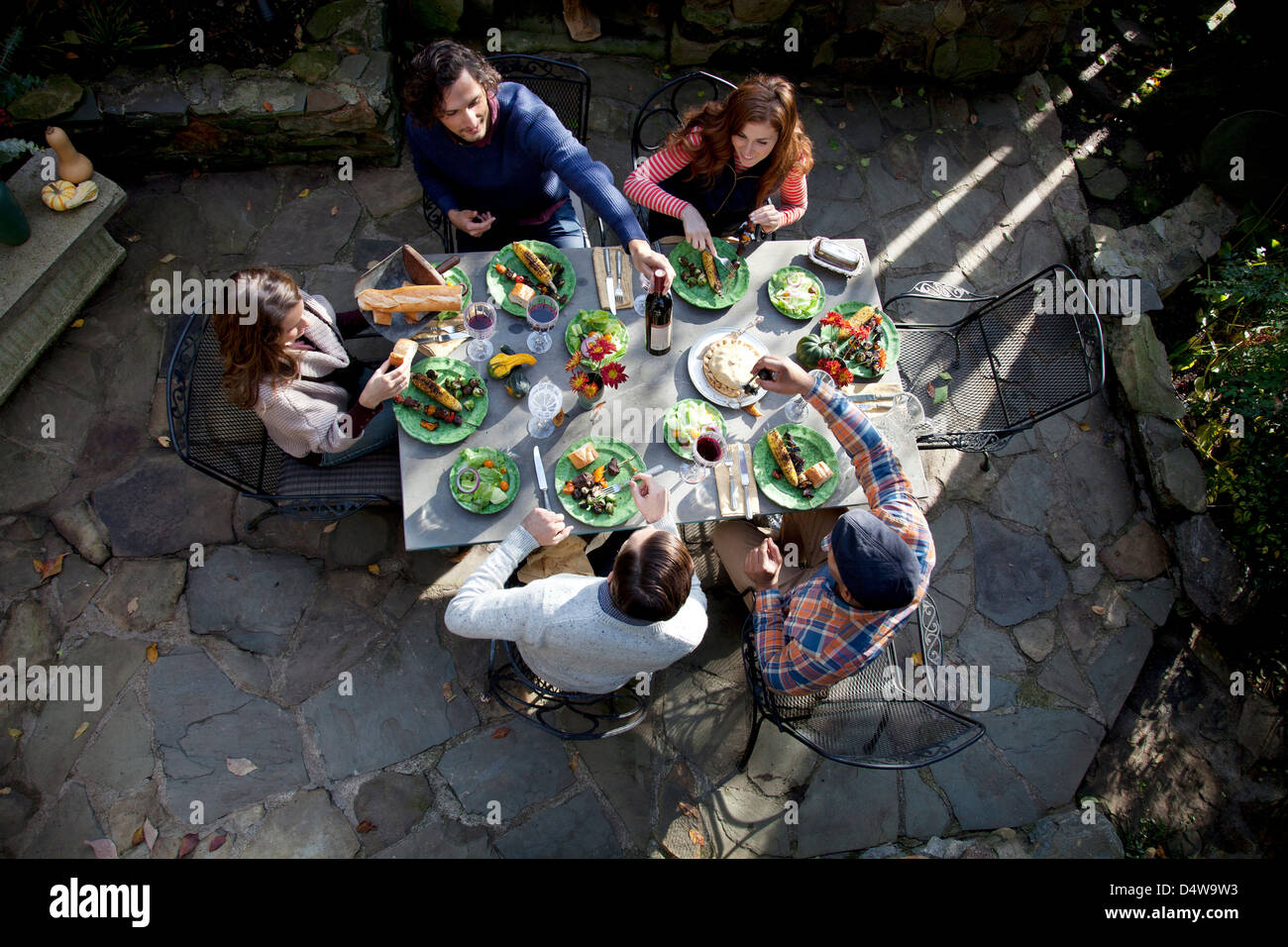 Friends eating together outdoors Stock Photo - Alamy