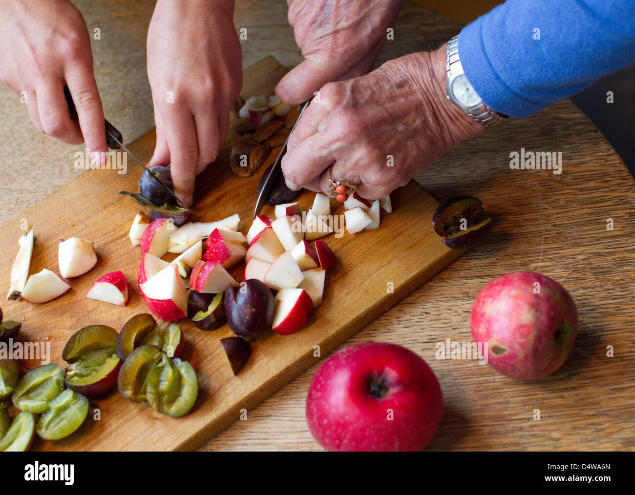 Senior Klara Fuerst (78) and student Sarah Boehm (20) cut fruit in ...