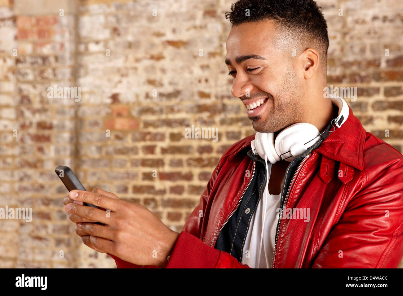 Smiling man using cell phone Stock Photo - Alamy