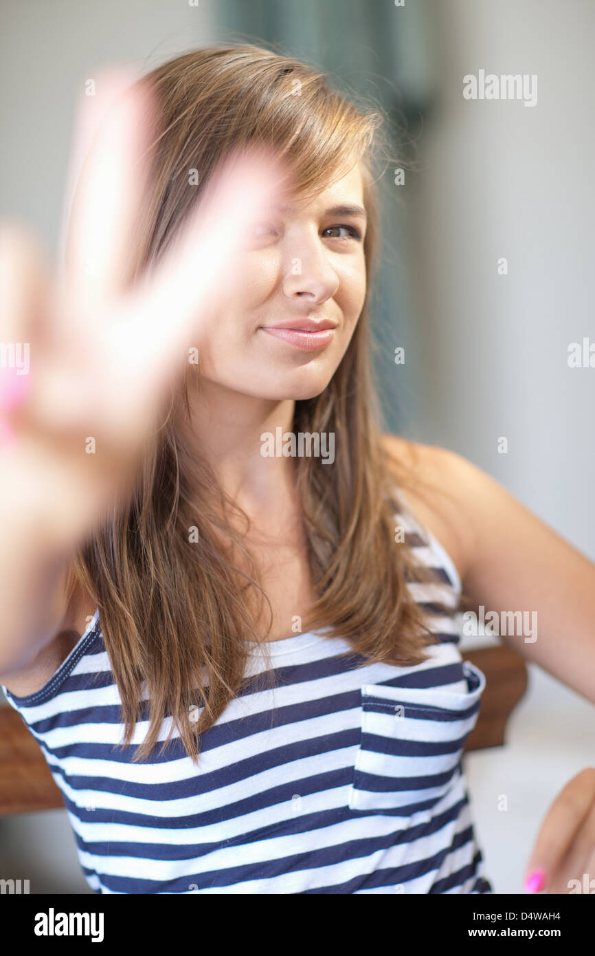 Teenage girl making peace sign Stock Photo - Alamy