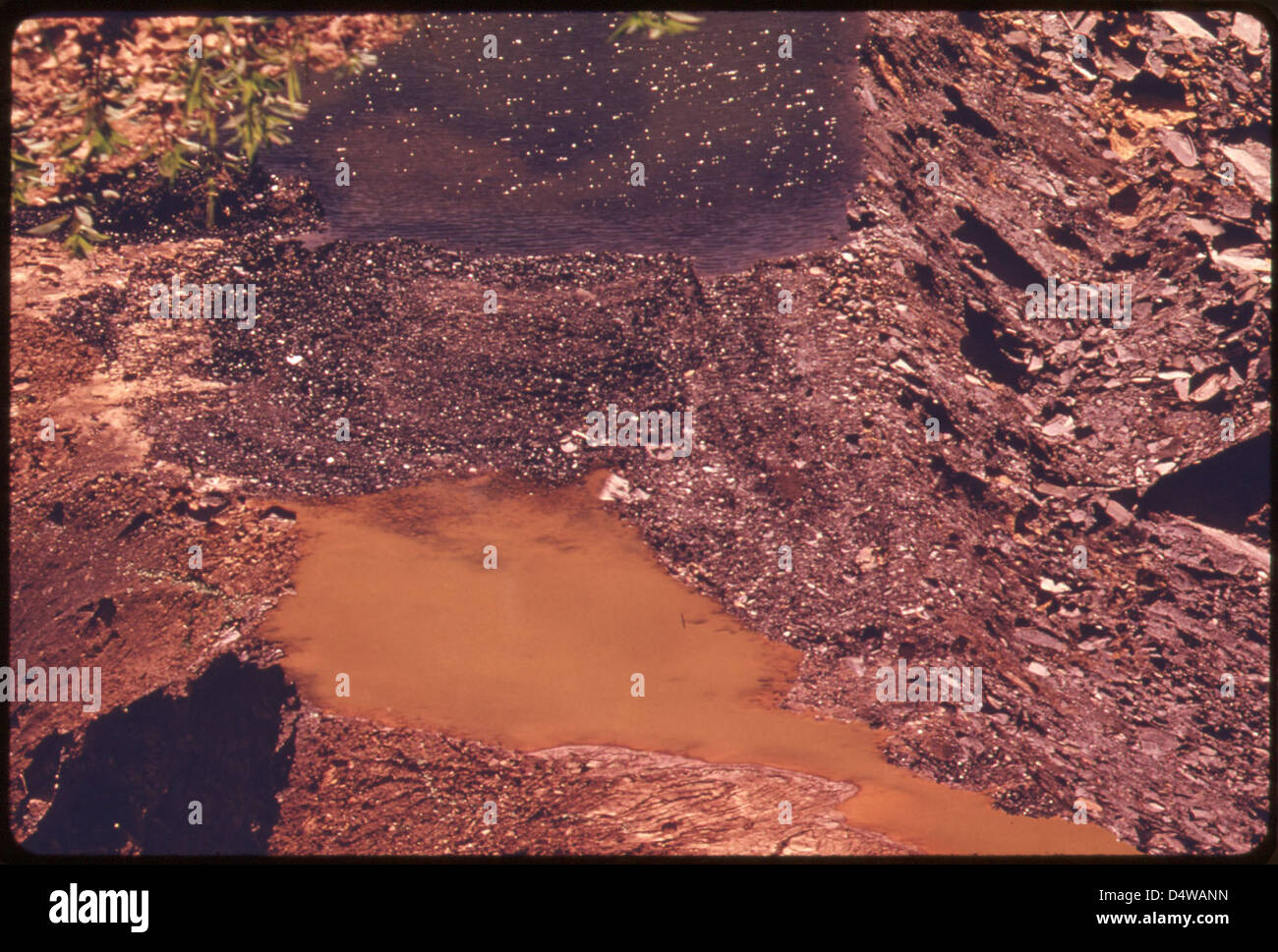This July 1974 photograph depicts discolored water in a strip mine pit ...