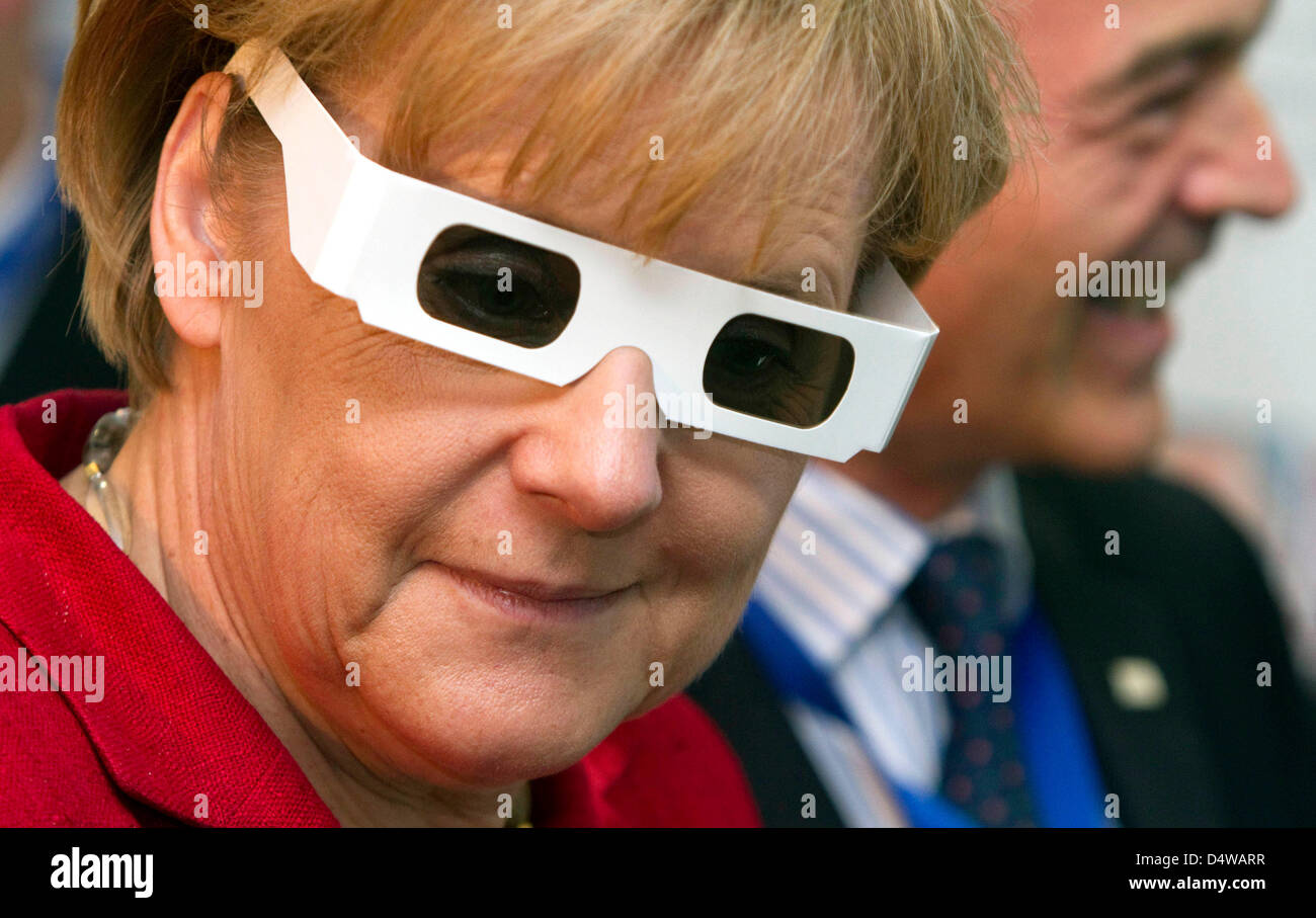 German Chancellor Angela Merkel checks out 3D glasses at the 'Material ...