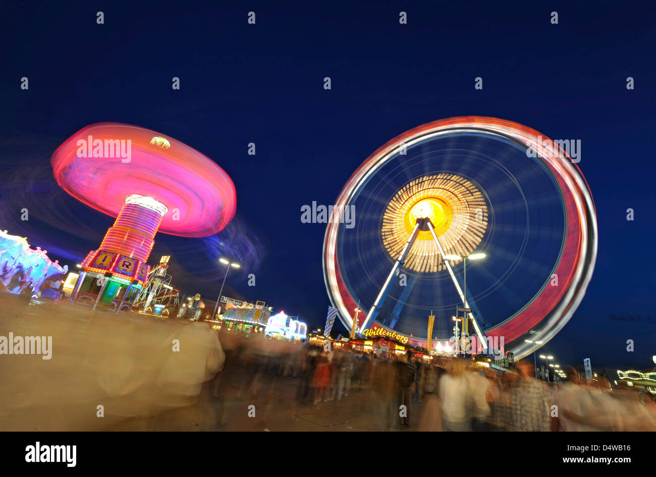 Visitors ride a ferris-wheel and a roundabout at the 2010 Oktoberfest ...