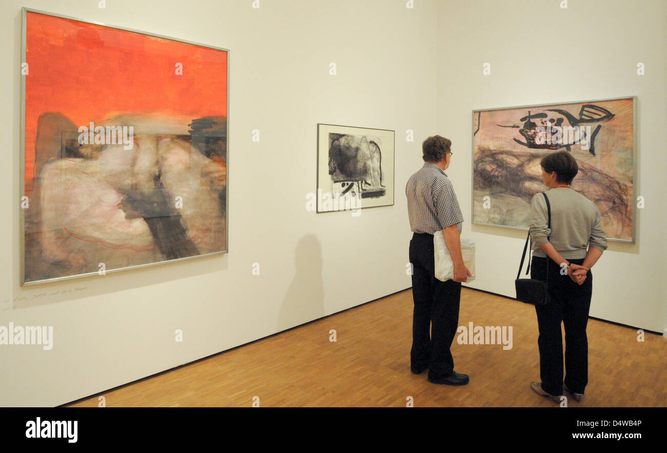 People eye works of German artist Arno Rink during an exhibition on ...