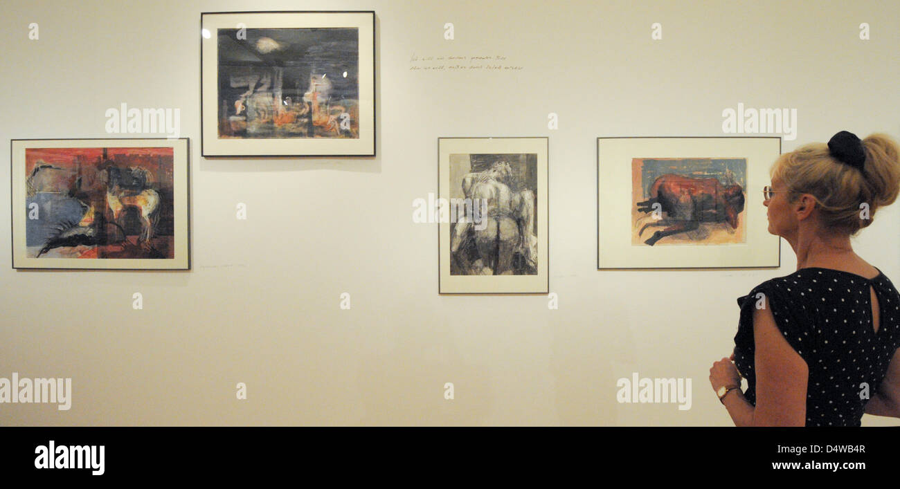 People eye works of German artist Arno Rink during an exhibition on ...