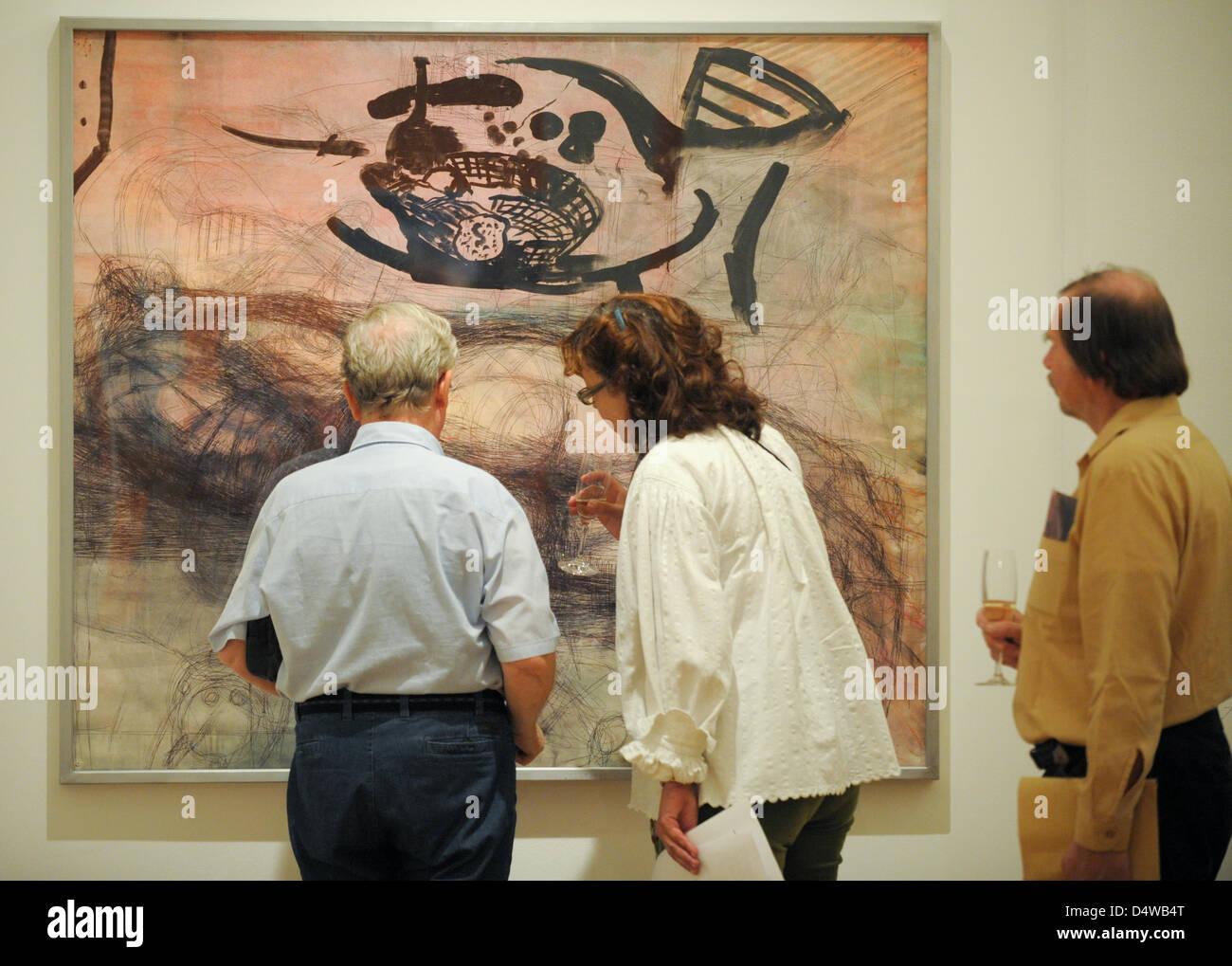 People eye works of German artist Arno Rink during an exhibition on ...