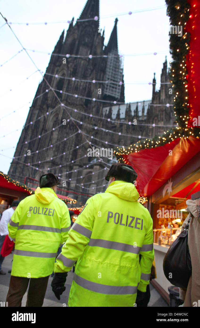 Police officers walk over the christmas market in Cologne, Germany, 22 ...