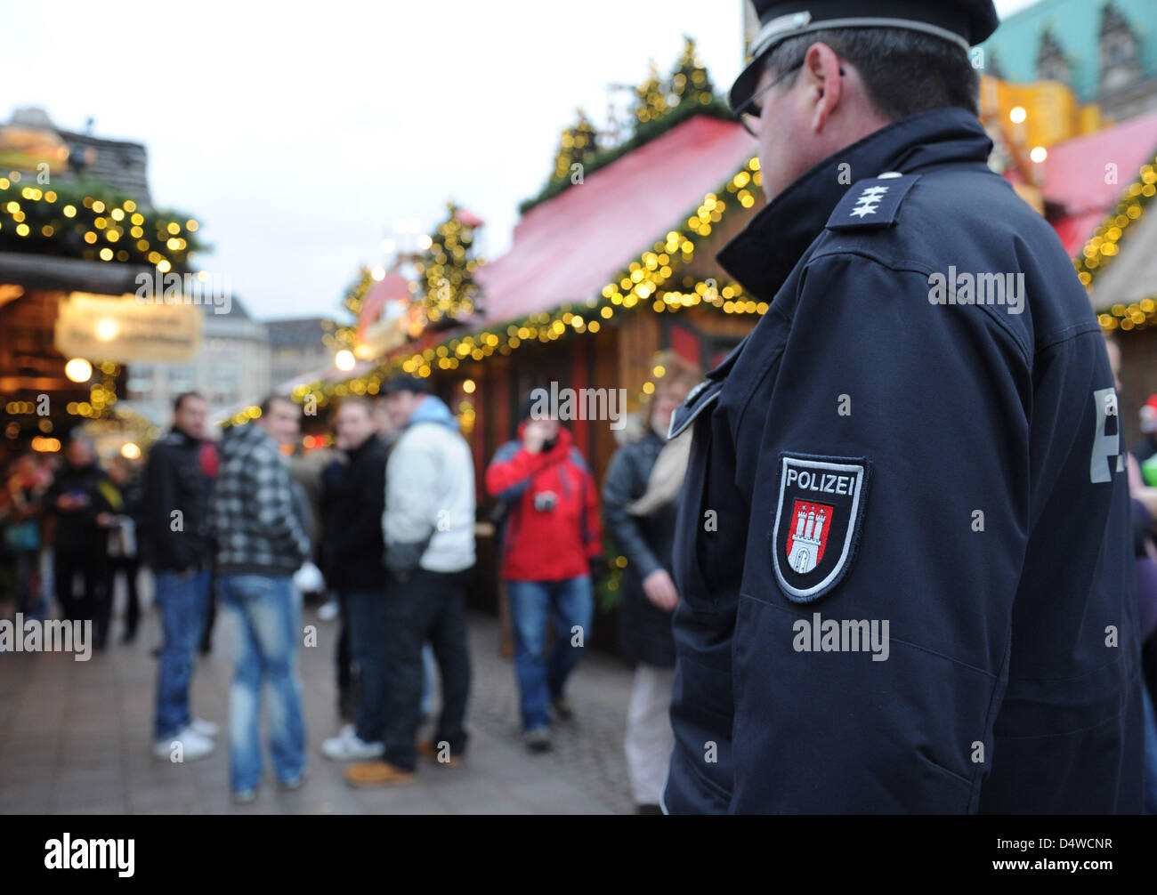 Police officers walk over the christmas market in Hamburg, Germany, 22 ...