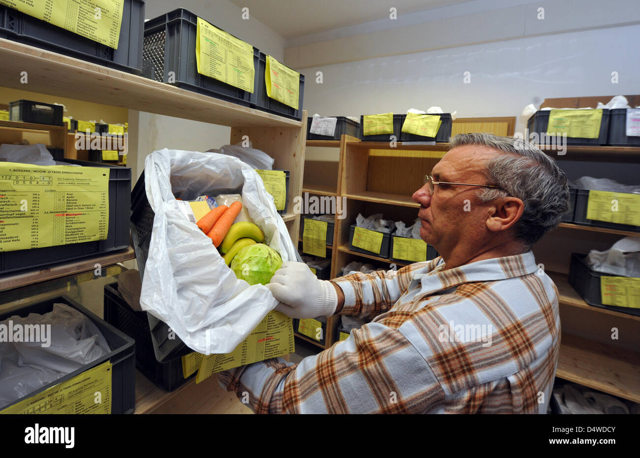 An employee checks untouched food at a house for asylum-seeker's in ...