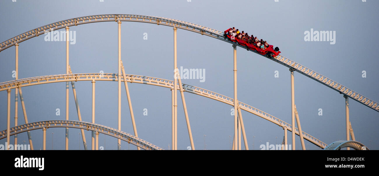 Visitors of the Ferrari World theme park sit in a rollercoaster in Abu ...