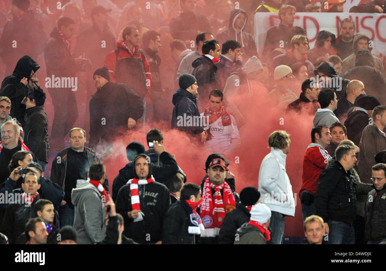 Bayern Munich's fans are pictured on the stands between smoke-bombs ...