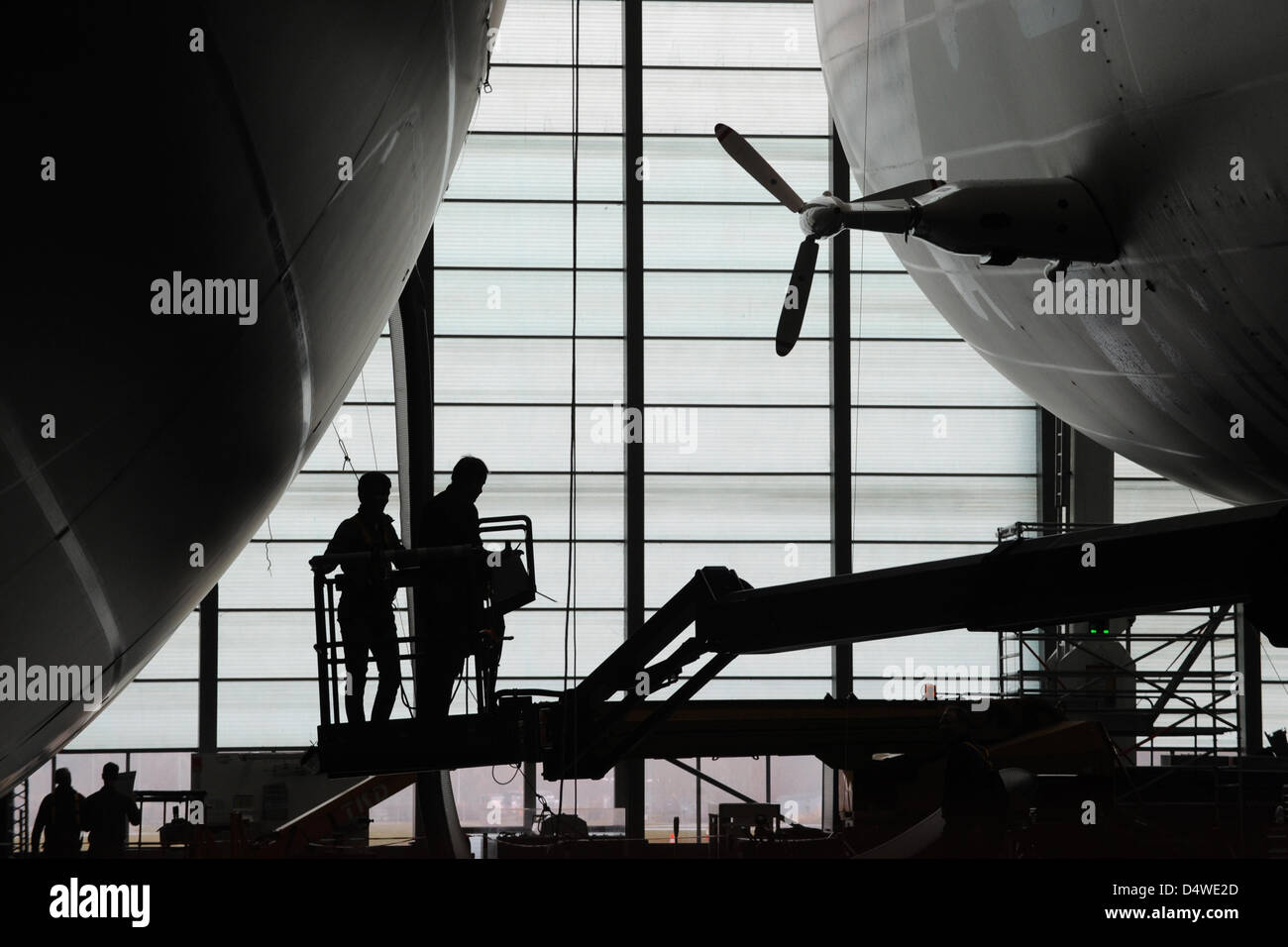 Two employees of the Zeppelin aircraft works drive along the mantle of ...