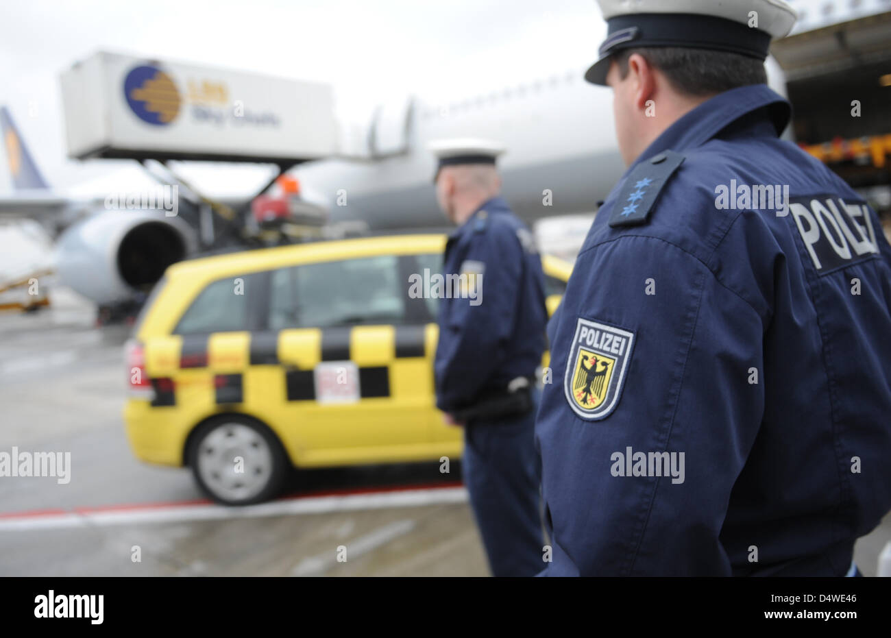 Police officers monitor the apron of the airport of Munich, Germany, 24 ...