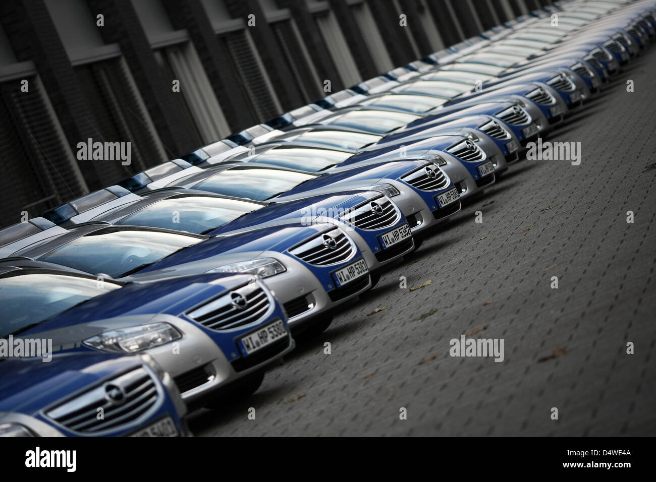 Brand-new police cars by Opel are lined up in front of the police ...
