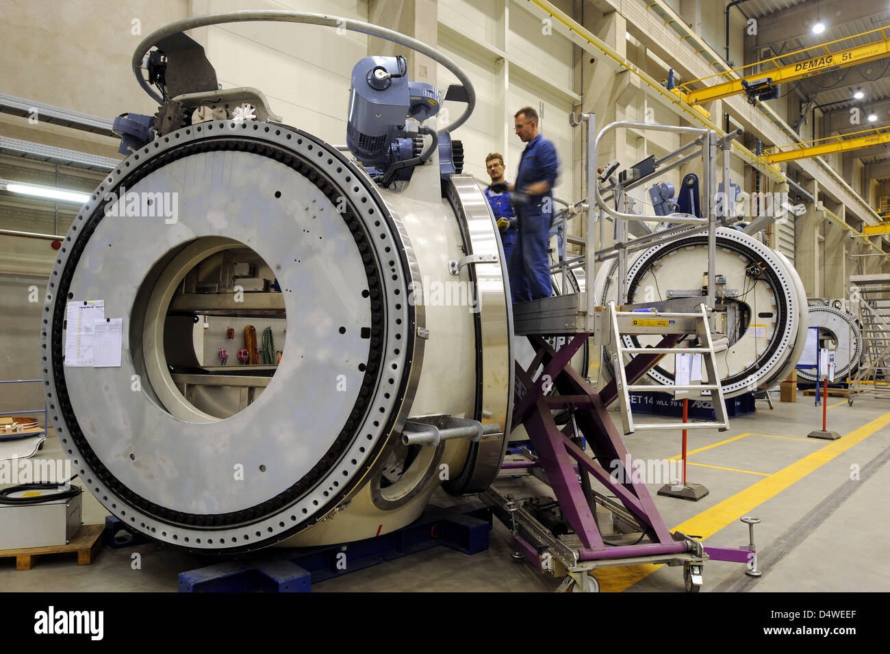 Mechanics assemble joint elements for propellers at a factory hall of ...