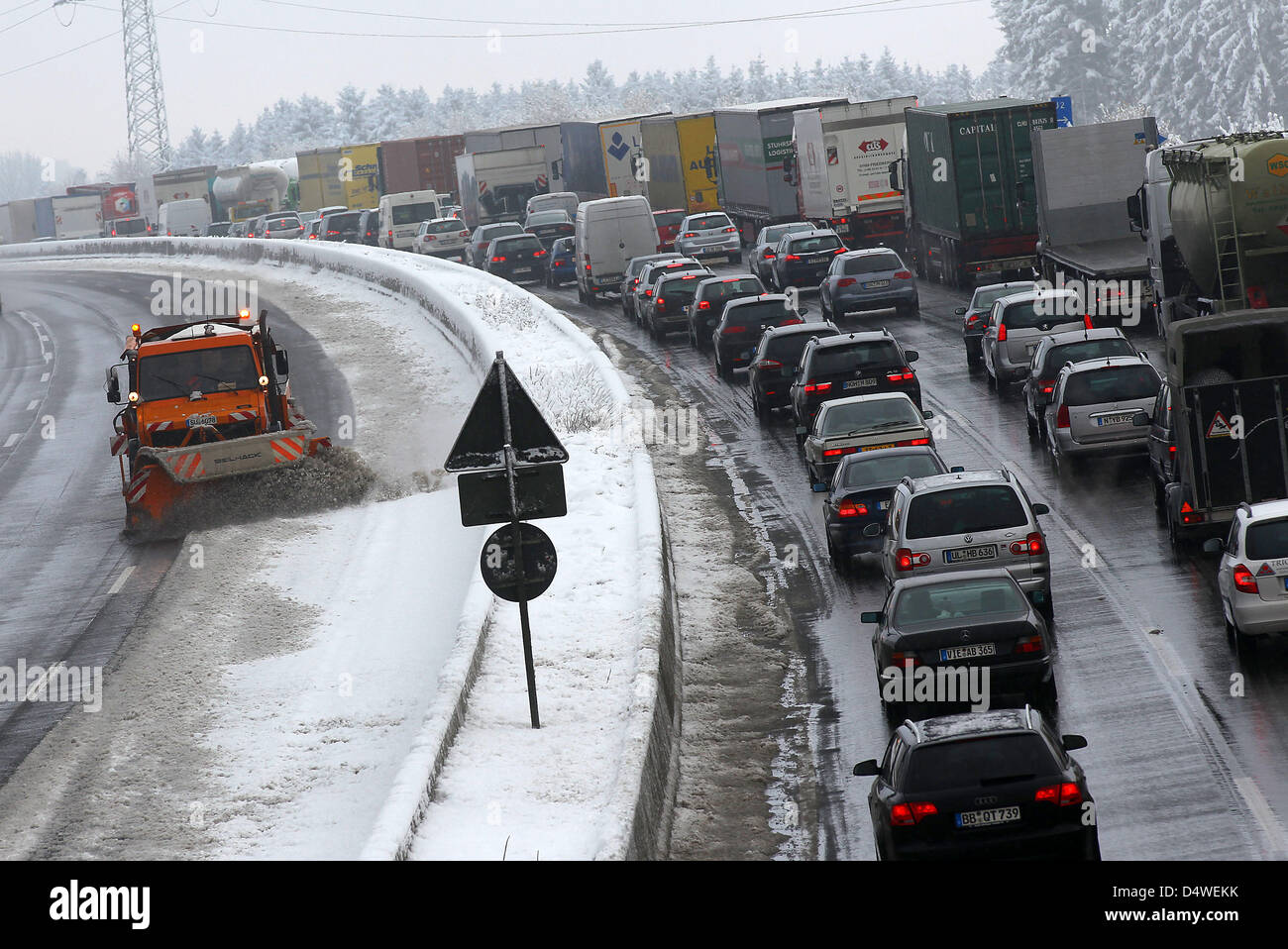 A snow clearing vehicle clears snow next to a traffic jam near Bad ...