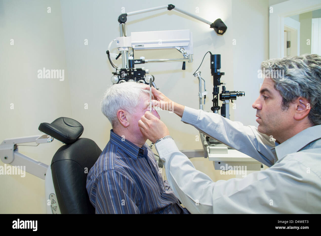 Male doctor examining patient eye hi-res stock photography and images ...
