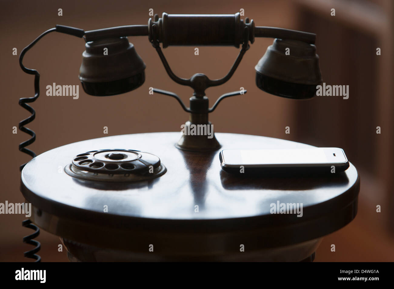 Cell phone by antique phone Stock Photo - Alamy