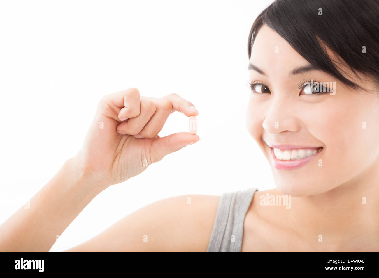 smiling Young woman with pill Stock Photo - Alamy